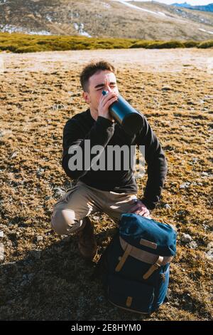 Thermos and backpack of tourist on meadow in forest Stock Photo - Alamy