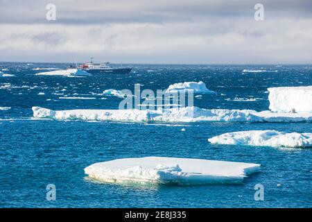 Cruise ship behind icebergs, Brown Bluff, Tabarin Peninsula, Antarctica ...