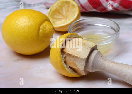 Lemon, lemon juice in peel and lemon squeezer Stock Photo - Alamy