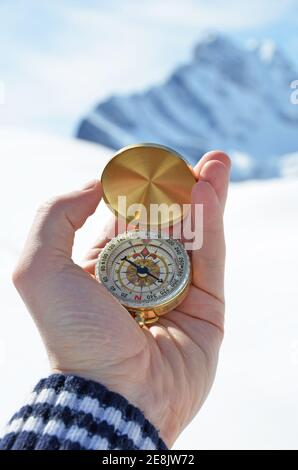 Compass in the hand against snowy mountains Stock Photo - Alamy