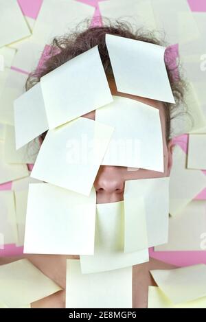 The woman's face is pasted over with blank stickers on a pink ...
