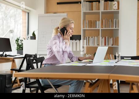 Young accountant with smartphone to call marketing consultants and ...
