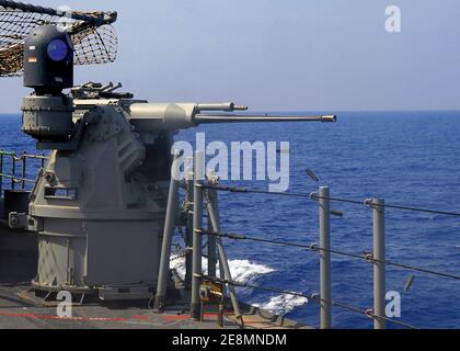 An MK-38 25mm gun system is fired during a live-fire exercise aboard ...