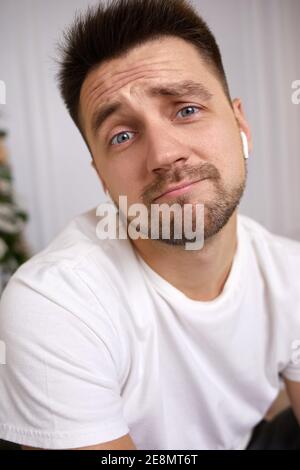 Portrait of a sad man talking on a telephone Stock Photo - Alamy