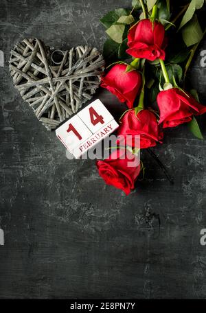 Calendar with date 14 FEBRUARY and roses on table in living room ...