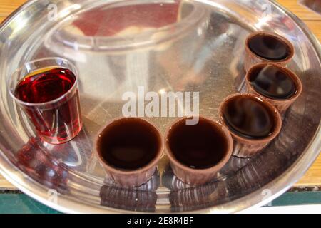 Ginja de Obidos, traditional sour cherry liquor, served in small cups ...