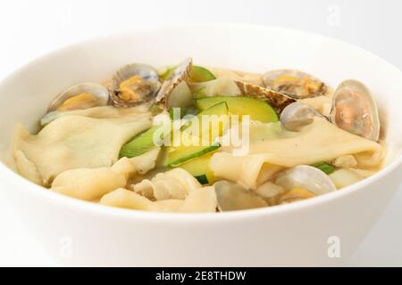Cooking clam flour broth on a white background Stock Photo - Alamy