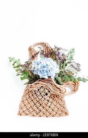 Top view of a bouquet of pink hydrangeas on a black and orange surface ...