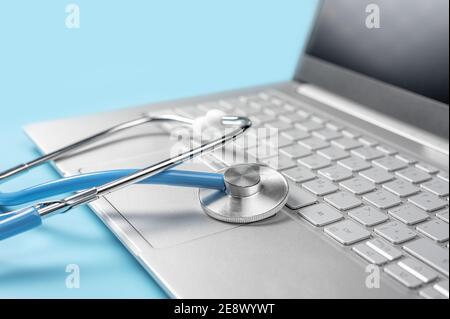 Stethoscope keyboard laptop computer isolated on blue background ...