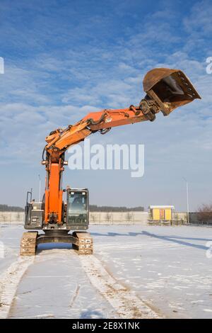Raised excavator bucket against the blue sky. Copy space Stock Photo ...