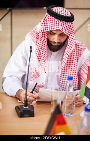 Arabic muslim business people gathered for meeting Stock Photo - Alamy