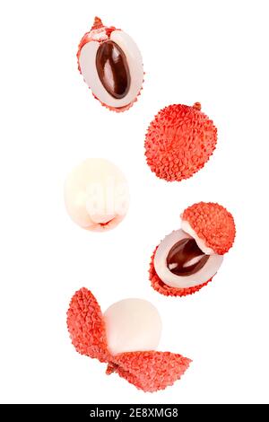 Fresh lychee fruits in white ribbed bowl with green leaves on textured ...