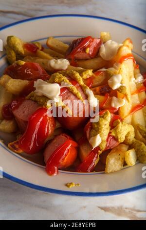Peruvian fast-food salchipapas french fries and sliced sausage Stock ...