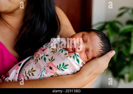 baby Cradled in Arms Stock Photo - Alamy