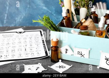 Alchemical symbols and ingredients for preparing potions on dark wooden ...