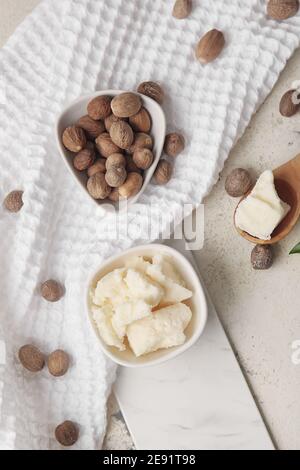 Shea butter and nuts on light background Stock Photo - Alamy