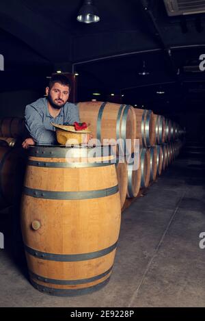 Vertical shot of a straw hat with red ribbon isolated on a light gray ...