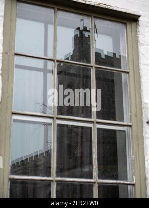 Reflection, in a double glazed window, of an old building in the Grand ...