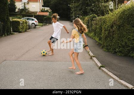brother and sister playing with soccer ball Stock Photo - Alamy