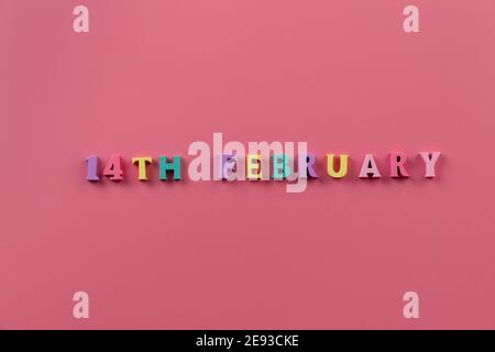 The word "LOVE 14th February" banner. Multicolored letters on pink ...