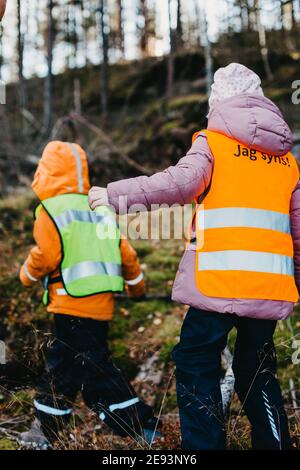 Rear view of children wearing reflective vests Stock Photo - Alamy