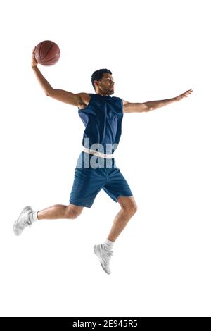 Slam dunk. Young arabian muscular basketball player in action, motion ...