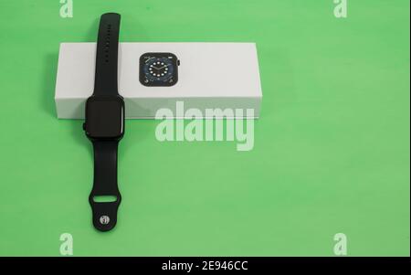 Smartwatch and a box isolated on green background Stock Photo - Alamy