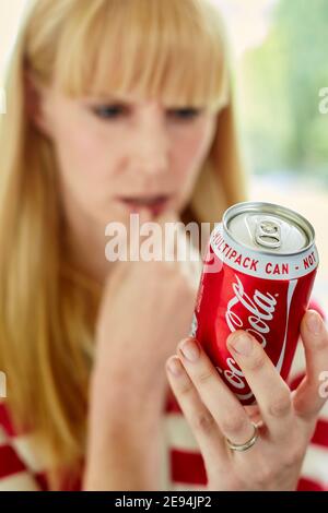Woman drinking Coke from a tin Stock Photo - Alamy