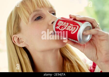 Woman drinking Coke from a tin Stock Photo - Alamy