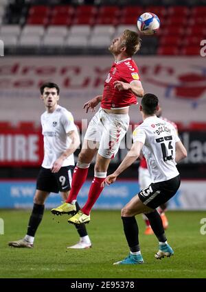 Jayden Stockley of Charlton and James Bolton of Portsmouth battle for ...