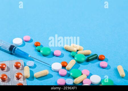 Colorful pills, blister and syringe on a black background Stock Photo ...