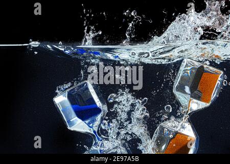 Hourglass diving into the water against black background Stock Photo ...