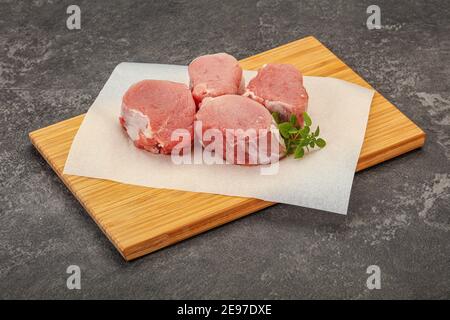 Raw pork medallion served rosemary for cooking Stock Photo - Alamy