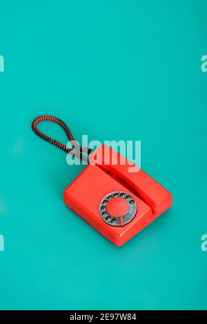 High angle of vintage turquoise telephone with its coiled cord ...