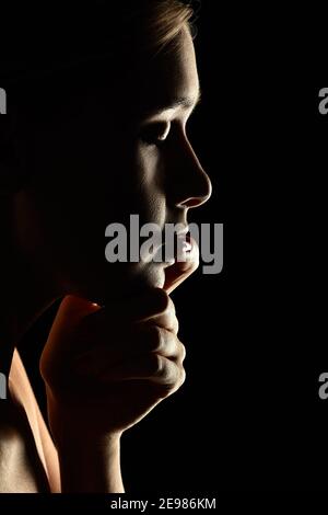 sad female face profile silhouette on black background Stock Photo - Alamy
