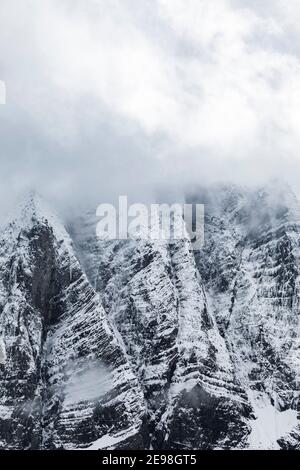 Snow on the nearly vertical cliffs of The Rockwall on Floe Peak ...