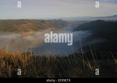 Pacific ocean fog fills the coastal valleys on Big Sur, California ...
