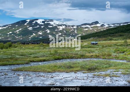 Turquoise River landscape and Arasluokta sami indigenous settlement ...