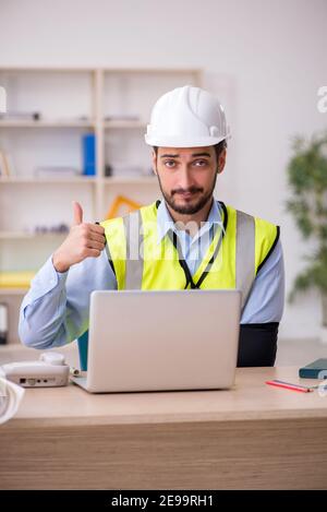 Young arm injured architect working in the office Stock Photo - Alamy