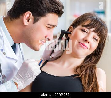 Doctor checking patients ear during medical examination Stock Photo - Alamy