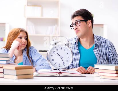 Two students runnng out of time to prepare for exams Stock Photo - Alamy