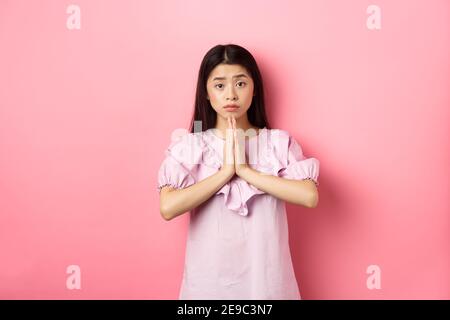 Please. Young asian teen girl asking for help, begging and looking ...