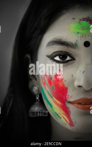 A YOUNG WOMAN WITH GULAL ON HER FACE LOOKING AWAY AND LAUGHING Stock ...