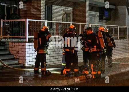 Firefighters pictured at the scene of a fire in an apartment building ...