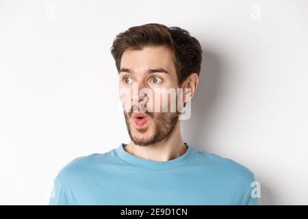 Close up of impressed caucasian man say wow, showing empty smartphone ...