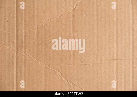 Brown corrugated cardboard texture with wrinkles and creases. Carton ...