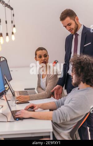 Manager overseeing his employees beautiful blonde and a coworker with ...