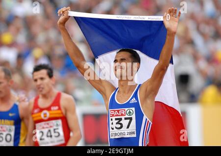 France's Mehdi Baala celebrates with the France National Flag as he ...