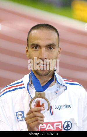 France's Bouabdellah Tahri poses with his bronze medal on the podium of ...