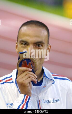 France's Bouabdellah Tahri poses with his bronze medal on the podium of ...